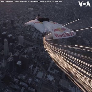 25K views · 241 reactions | The Red Bull Air Force celebrated the third and final super moon of 2019 with a fireworks-laden skydiving display on Wednesday, March 20. Two daredevils dropped from a helicopter 4,000 feet above downtown Los Angeles and swooped in at more than 120 mph. The pair drew their parachutes at 1,000 feet and landed safely on the city streets below. (AFP) | Voice of America | Facebook