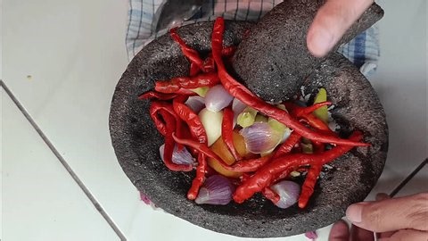 clip-4008269279-process-grinding-chili-sauce-which-has-been