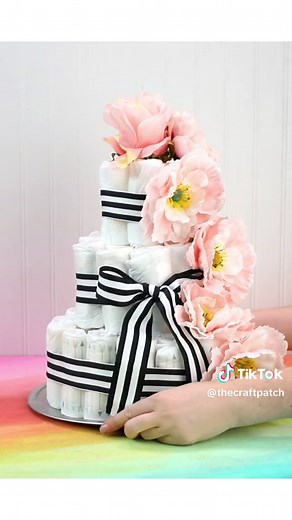 HOW TO MAKE A DIAPER CAKE - get the full tutorial with all the info you’ll ever need to make a diaper cake for your next baby shower. Just click my profile link, then tap the photo of this project. 👌 #babyshower #diapercake
