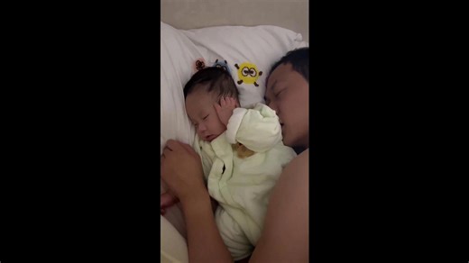 Baby covers her ears to muffle her dad's snoring