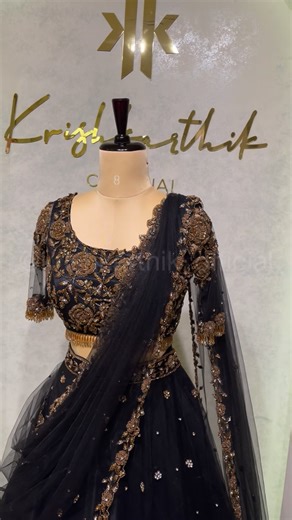 Karthiban d on Instagram: "“Midnight Royale” A vision sculpted in timeless black, Midnight Royale is an ode to modern regal elegance. This handcrafted lehenga features a richly embroidered blouse adorned with antique gold threadwork, intricate floral motifs, and delicate embellishments that shimmer subtly under light. The voluminous skirt flows in layers of fine net, scattered with refined bootis and finished with a heavily detailed floral border that adds depth and grandeur to every movement. D