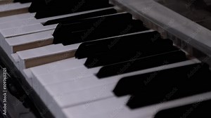 Piano or Grand Piano Playing Itself. Performing a musical composition on a piano that plays by itself. Self-Playing. White, black piano keys press independently without human intervention. Close up.
