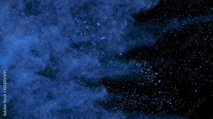 Realistic blue powder explosion on black background. Slow motion movement with acceleration from left of screen.