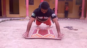 An incredible video shows a Pakistani fitness fanatic setting a new world record for most reps of two finger push-ups in one minute carrying a 40lbs weight on his back. | Storytrender