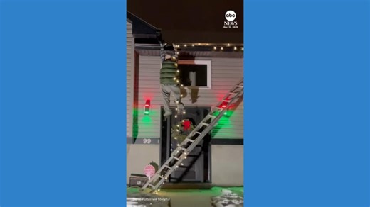 Concerned neighbors check on robotic Clark Griswold hanging from gutter