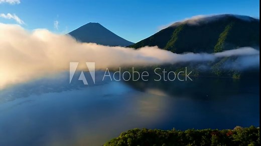 aerial view of famous Mount Fuji in Japan, establishing shot of symbol of Japan, amazing aerial view of Fujiyama mountain, flying through the fog towards Fuji, Fuji five lakes, Japanese tourism