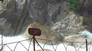 Yang Bay waterfall. Vietnam. sunny day. waterfall rapids. label stop