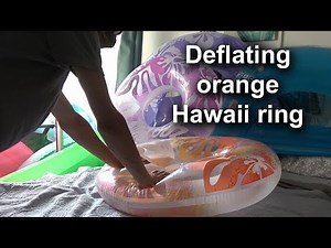 Deflating orange Hawaii intex swim ring