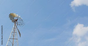 Vintage Farm Equipment, Windmill turning in the breeze. Wind Power.