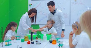 Hand with soapy water mixed with flammable substance is set on fire with a lighter. Children studing chemistry in school laboratory