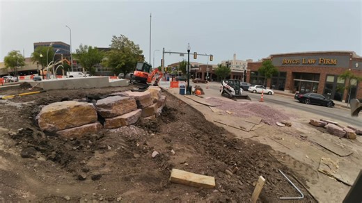 Stacking quartzite! Working with natural stone has its challenges, but the results are great. Quartzite is one of the densest stones out there - perfect for gravity walls like this one. Just need a big excavator to get it done! | Urban Oasis Outdoor Living
