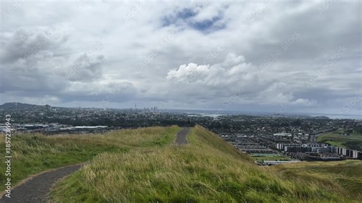 A panoramic view of Auckland city from a dormant green volcano mountain crater.