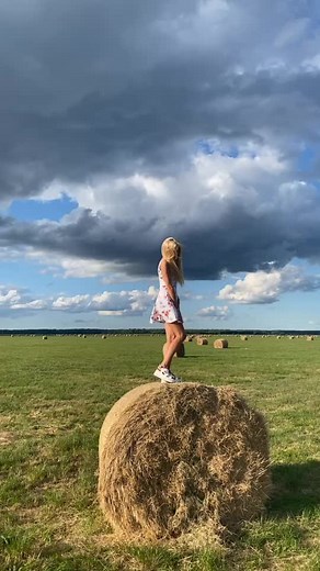 Enjoying Summer on a Hay Bale in a Sunny Field