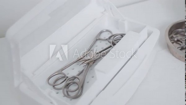 Manicurist preparing instruments for nail care procedures using professional medical equipment. Hardware sterilization of medical manicure tools using the dry heat method