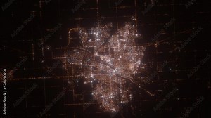 Saskatoon (Canada) aerial view at night. Top view on modern city with street lights. Camera is zooming out, rotating counterclockwise. Vertical video. The north is on the left side