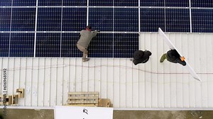 Modern solar panels produce clean electricity. Solar technician installing solar panels on house roof. Concept.renewable energy, technology, electricity, service, green, future. power plant.