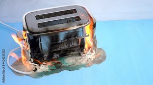 Toaster on fire. Household electrical appliance fire hazard. Overload. Short circuit. Carelessness. Safety in home. Danger home inflammation Insurance concept