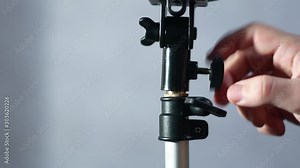 Connect and enable a small studio flash. Installation of light in the studio