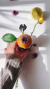 point of view, woman, setting down, muffin, table, flowers, bakery, floral arrangement, food, dessert, bakery goods, pastry, setting, setting table, setting up, table setting, decoration, floral decor
