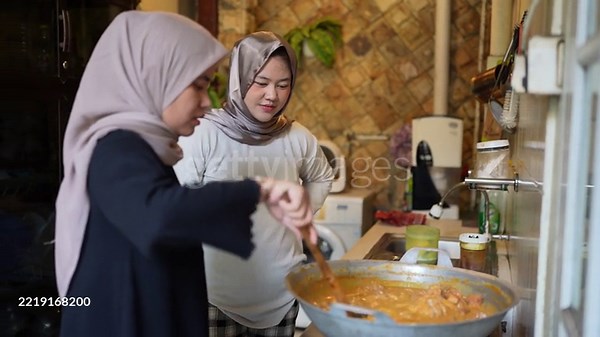 two woman cooking in the kitchen