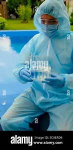 take a water sample from the pool. Selective focus. summer.