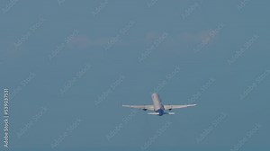 Passenger airliner climbing after takeoff in the blue sky. Rear view long shot, plane fly away