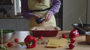 Woman is preparing tasty meal to bake, adding favorite spices, preferring domestic appetizing food, cooking inspiration, Slow motion.