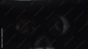 First-person perspective view (point of view POV) holding virtual reality goggles with hands, looks this device over and finally puts it on his head or face.