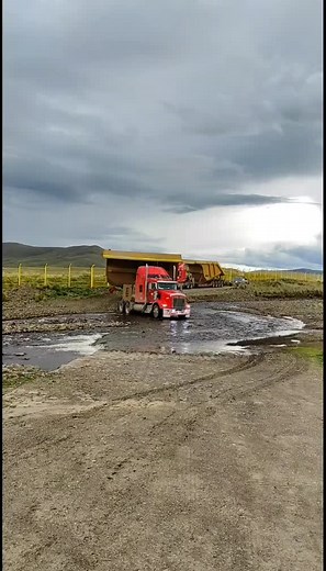 Heavy-Duty Truck Navigates Muddy Water Crossing