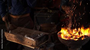 Close-up, Blacksmith cowboy man work, the horseshoe is worked on anvil with forging hammer. Pliers hold the horseshoe securely. The blacksmith demonstrates work in the workshop. Cowboy 1800s Concept.