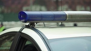 clip-1057606219-police-flasher-flashing-on-roof-patrol-car