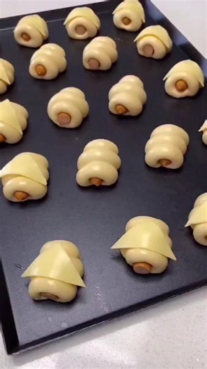 Sausage cheese rolls 🥰 preparation in the mixer bowl bread flour 500g Instant yeast 8g sugar 40g fresh milk 240ml one large egg knead the dough for 8min butter 50g Salt 5g knead the dough for 4min rest the dough for 60min separate the dough into 40g each piece make balls cover the dough rest the dough for 15min make the rolls sausage rest the dough for 40min brush with eggs cheese slice sauce for the top cream cheese philadelphia 250g milk 15ml mix well Bake in a preheated oven 190C 15 to 18min