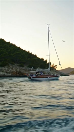✨🌅 Sailing into Serenity — A timeless wooden sailboat glides through emerald waters under a golden Mediterranean sunset. Calm breeze, soft waves, pure peace. 🌊⛵ #SunsetSailing #MediterraneanDream #SailingVibes #TranquilWaters #BoatLife #OceanPeace #GoldenHourSail #SeaEscape #ClassicYacht #SailingInStyle | Love Sailing