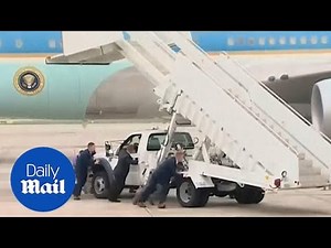 Moment officials push passenger stair truck away from Air Force One