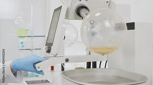 Close up of chemist extracting cbd with rotavapor in laboratory