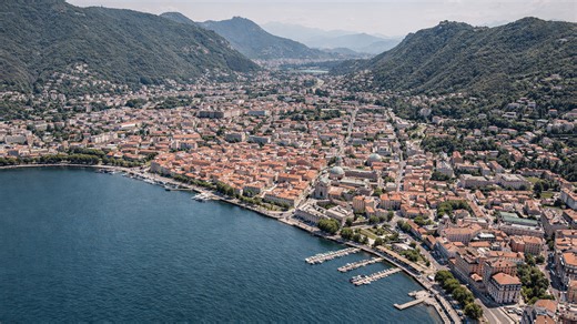 Lake Como cityscape framed by forested mountains