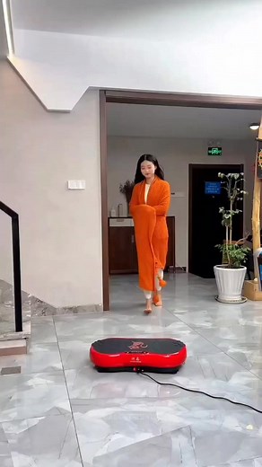 This compact electric fitness device features a flat platform that oscillates when activated. The machine is shown being used in various positions, including standing and sitting, demonstrating its suitability for different exercises. Its small footprint suggests it can be used easily within an indoor home environment. A digital display is visible on the platform for adjusting controls and settings. | Clinic cares