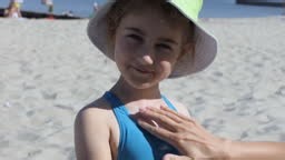 Mother Applying Sunblock Cream on Kid. Mom Applying Sunscreen Lotion...