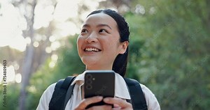 Woman, cellphone and backpacker trekking in nature or internet location as navigation or online compass, search or tree. Asian person, smartphone and smile or hiking journey or direction, view or web