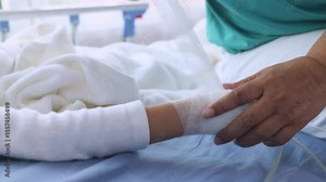 Nurses gauze wrap the wrist wound and give saline young girl, preventing the patient from pulling, scratching scratching the area where the saline was given which could cause inflammation infection.