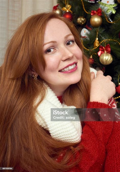 Beautiful Redhead Girl Portrait In Christmas Decoration Home Interior With Fir Tree And Ts