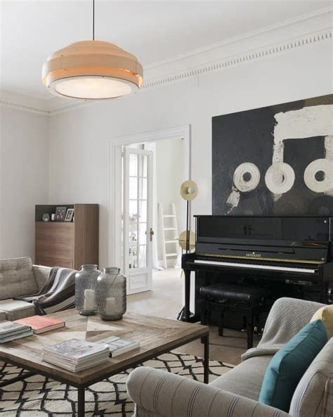 A Living Room Filled With Furniture And A Piano In Front Of A Painting