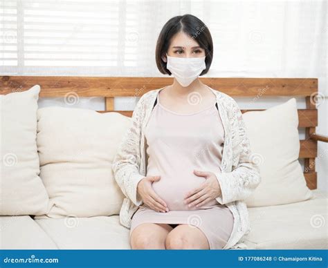 Asian Pregnant Women Wearing Medical Mask Due To Illness Dizziness