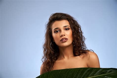 Free Photo Woman Hiding Naked Chest Behind Big Green Leaf