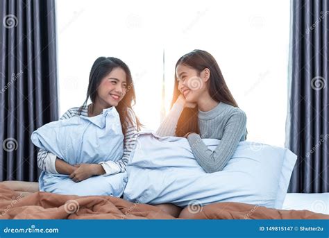 Two Asian Lesbian Women Looking Together In Bedroom Couple People And Beauty Concept Stock