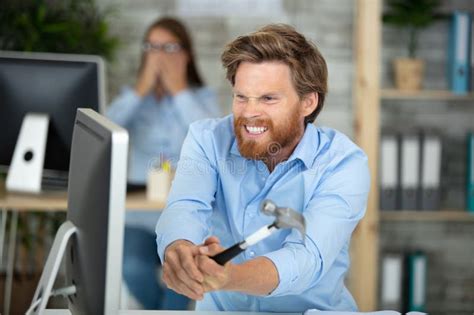 Angry Businessman Smash Computers Screen With Hammer Stock Image