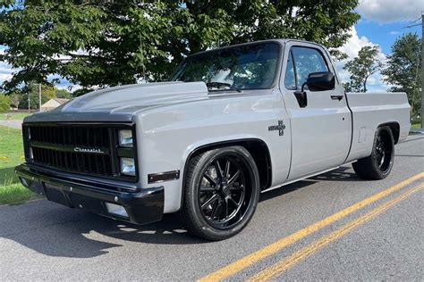 A White Truck Is Parked On The Side Of The Road