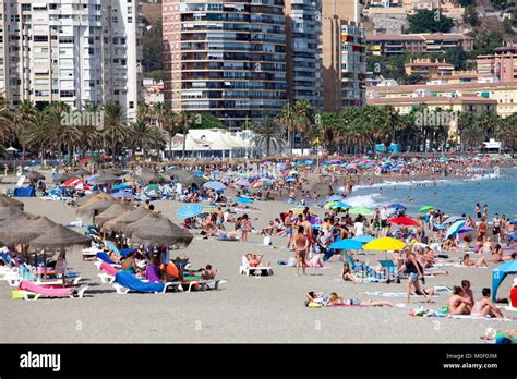 Sunbathers Tourists And Locals Enjoying The Sun Sea And Sand At Playa