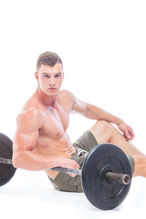 Muscular Man Working Out In Studio Doing Exercises With Barbell At