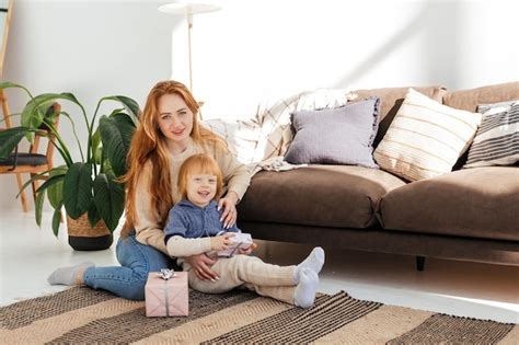 Premium Photo Red Haired Mom Cheerfully Prepares Christmas Ts With Her Son